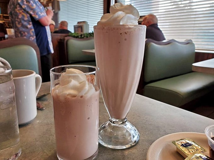 Milkshakes served in proper glasses with extra on the side; this is how dessert drinks should always be presented.