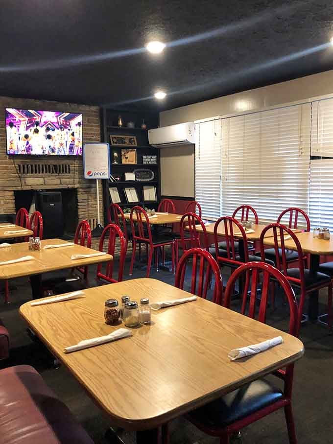 Simple wooden tables and red chairs creating the perfect backdrop for your next pizza adventure.