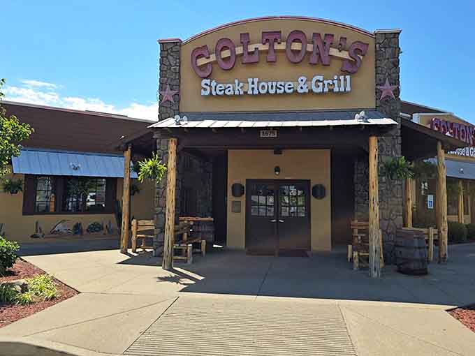 Rustic timber posts frame the entrance to steakhouse satisfaction where hearty appetites find their happy ending.