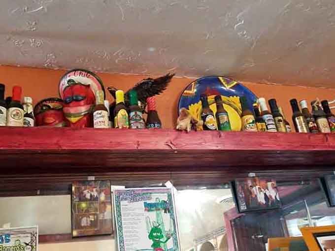 Hot sauce bottles and festive decorations line the shelves like trophies in a spice lover's hall of fame.