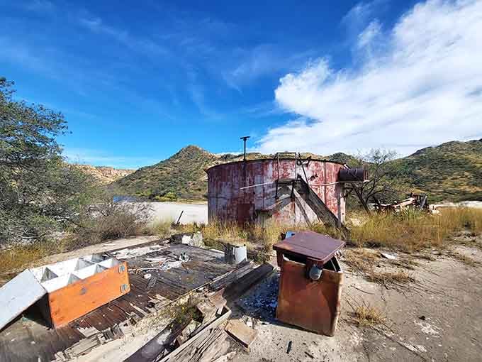Rusted mining equipment sits frozen mid-task, as if workers just stepped away for lunch and never quite made it back.