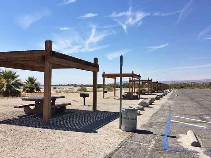 These shaded picnic spots offer respite from the brutal desert sun, though the view remains decidedly post-apocalyptic and fascinating.