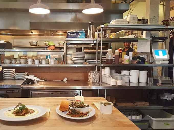 Behind the scenes, the open kitchen hums with activity as skilled hands transform ingredients into Southern comfort magic.