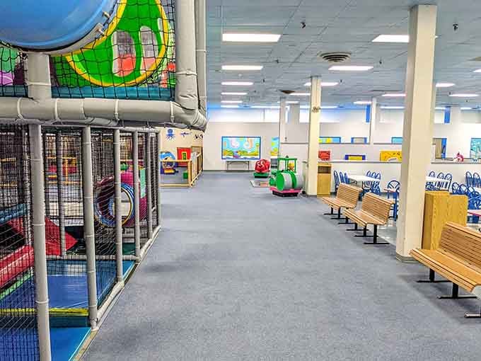 Wooden benches line the play area, giving parents prime viewing spots for supervising the controlled chaos unfolding.