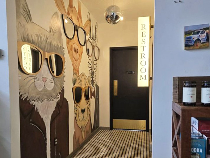 Even the restroom hallway gets whimsical artwork, because commitment to fun doesn't stop at the dining room door here.