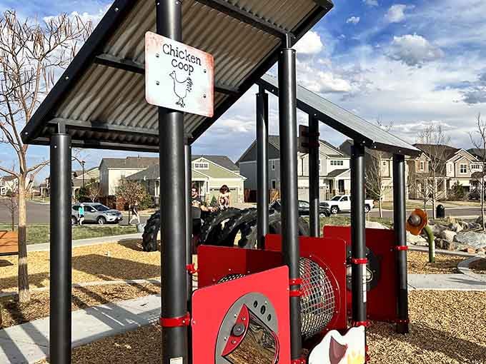 The chicken coop play structure proudly displays its theme, complete with corrugated metal and farmhouse charm.