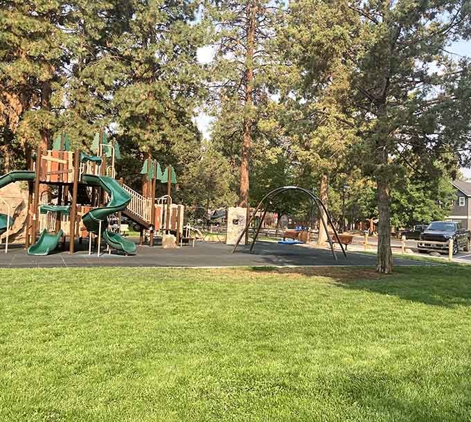 Village Green City Park offers the kind of playground where kids can actually be kids under towering ponderosa pines.
