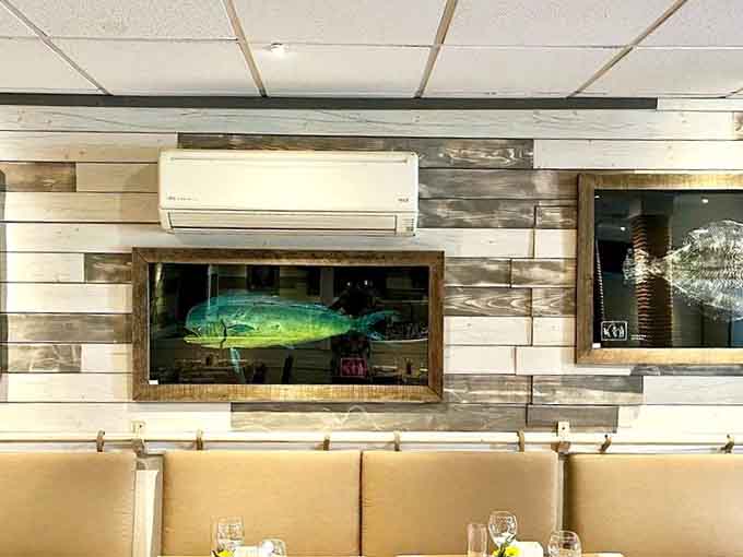 A decorative fish mounted on weathered wood adds coastal charm without turning the place into a nautical theme park nightmare.