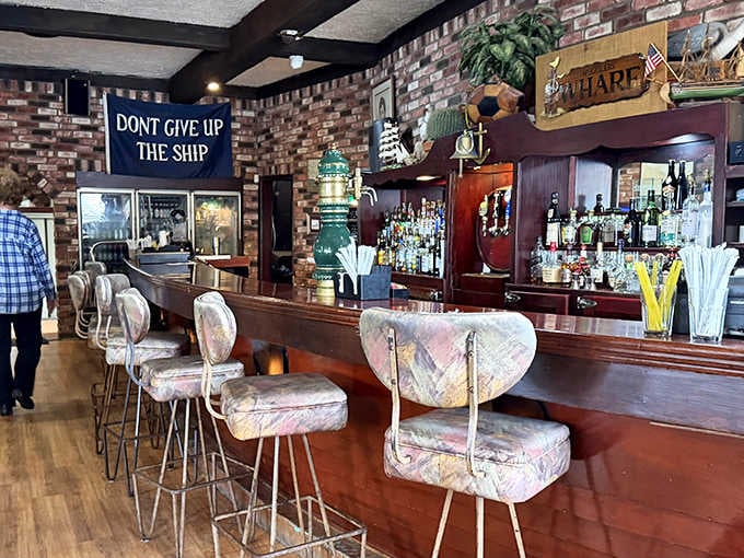 The bar area features unique seating and a "Don't Give Up The Ship" sign for proper maritime motivation.