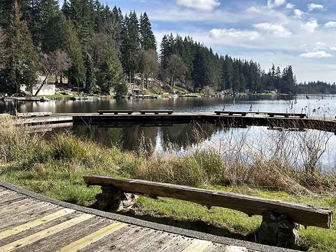 Flowing Lake's weathered dock extends into calm waters, inviting contemplation and possibly some very serious fishing or just peaceful sitting.