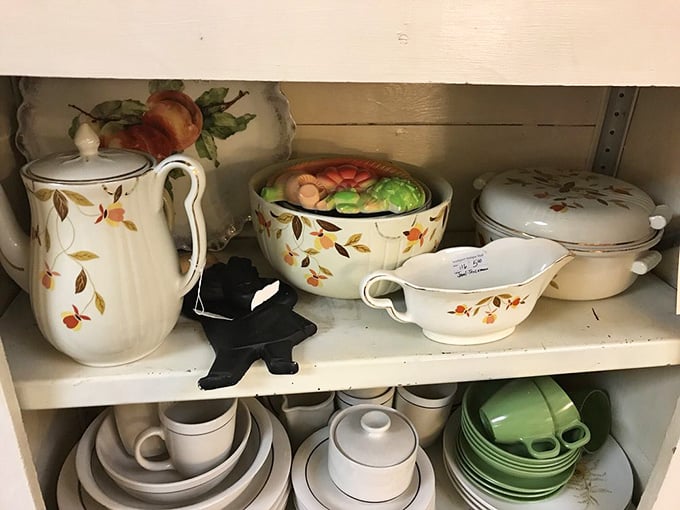 Autumn-themed dinnerware sits alongside modern pieces, proving every era had its own idea of table elegance.