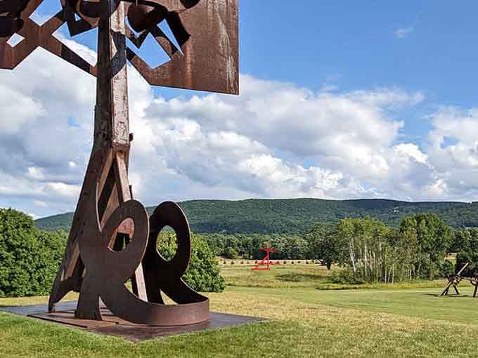 Weathered steel reaching toward clouds, a sculpture that looks equally at home in any season.