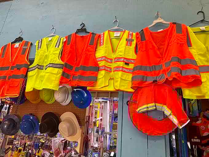 High-visibility safety vests hang in neon brilliance, proving that even practical workwear deserves its moment in the spotlight.