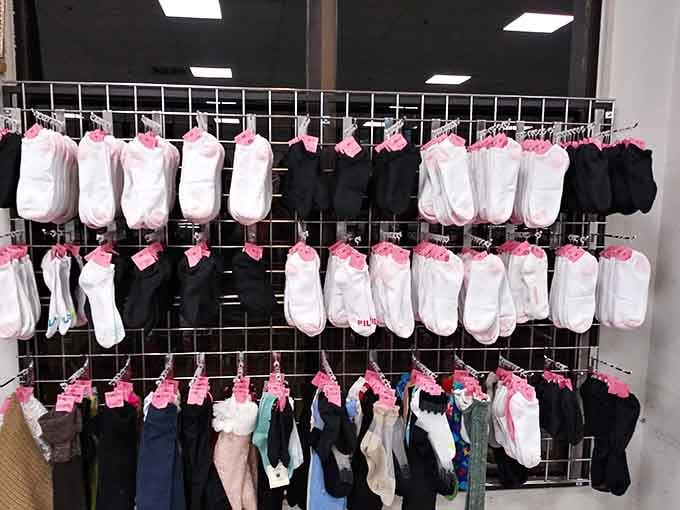 Socks displayed with pink tags like little flags of victory over overpriced department store hosiery.