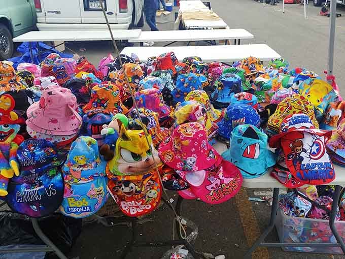 Character hats piled high in a rainbow explosion, because everyone deserves headwear that sparks joy.