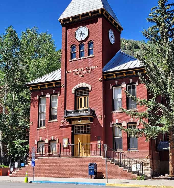 San Miguel County Courthouse towers in brick glory, its clock keeping mountain time since frontier days.