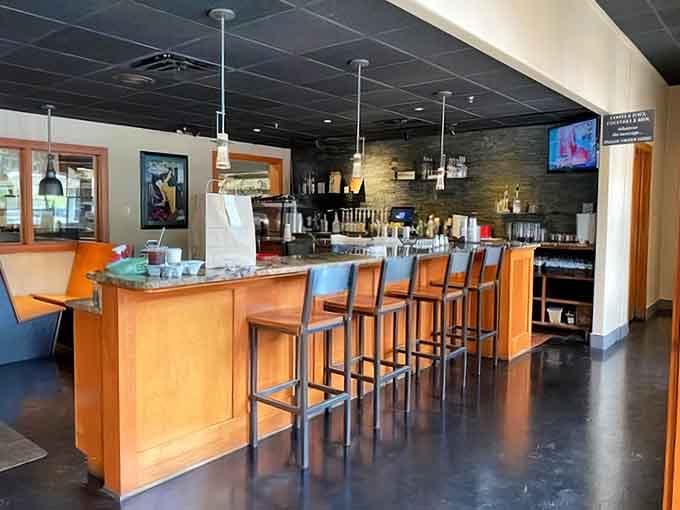 The bar area offers prime seating for solo diners who enjoy watching the breakfast magic happen up close.