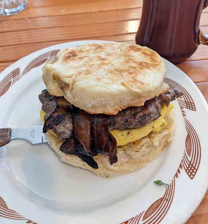 A breakfast sandwich stacked tall enough to require strategic planning and possibly an engineering degree to eat properly.