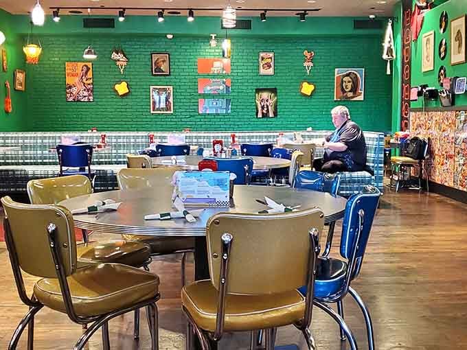 Mismatched chairs and eclectic wall art create a dining room that feels like your coolest friend's kitchen.