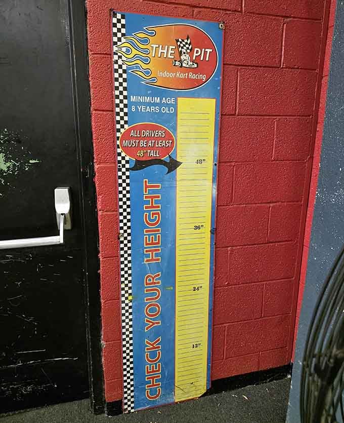 The height check ensures young racers meet safety requirements, because rules exist even in the pursuit of speed and glory.