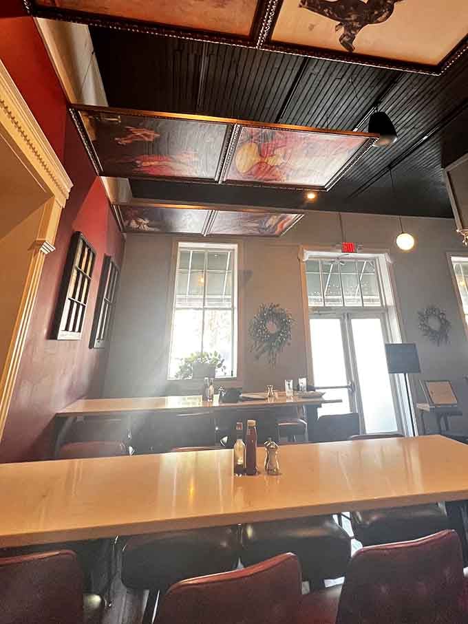 Portraits hanging from the ceiling create an unforgettable dining experience that's pure artistic ambiance.