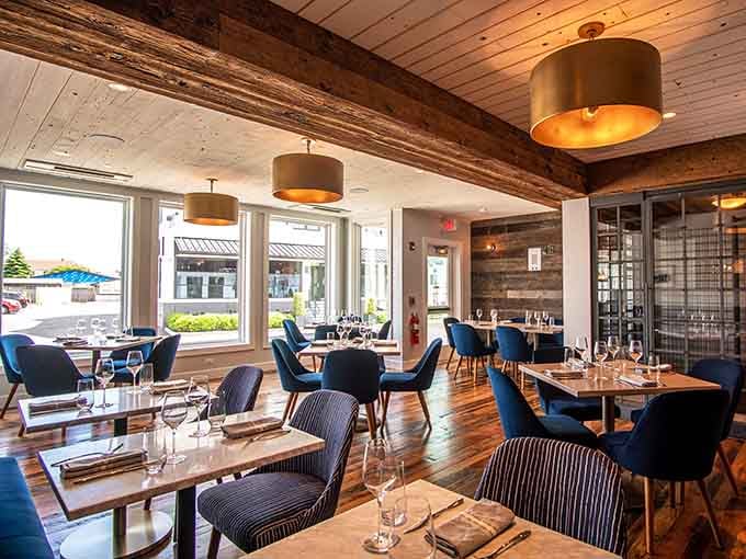 Navy chairs and natural light create a dining room that feels both upscale and genuinely welcoming.