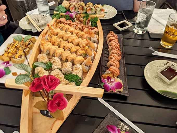 That wooden sushi boat overflowing with colorful rolls is the kind of feast that makes everyone at the table smile.