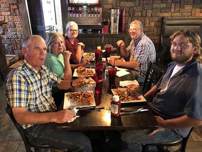 A full table of satisfied customers with loaded plates proves this place knows how to feed people right.
