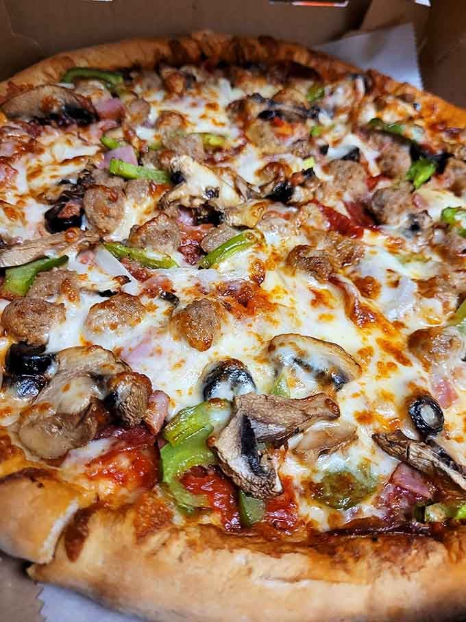 Every topping imaginable crowns this magnificent pie, a carnivore's dream that would impress even the pickiest pizza connoisseur.