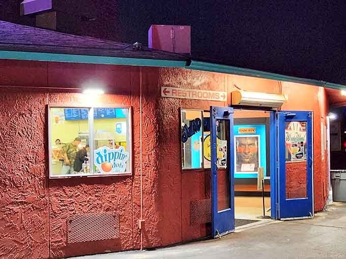Retro snack bar architecture glows warmly, beckoning moviegoers like moths to a deliciously nostalgic flame.