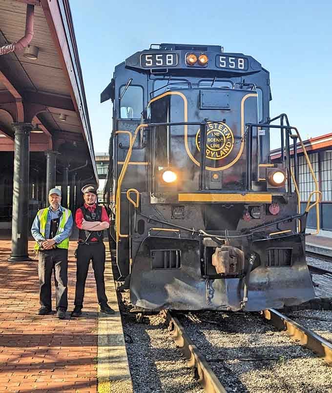 The dedicated crew members who make every journey safe and memorable, standing proud before their magnificent machine.