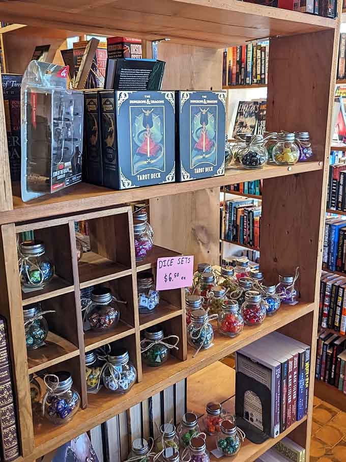 Tarot decks and dice sets share shelf space with literary treasures in this delightfully eclectic merchandise display.