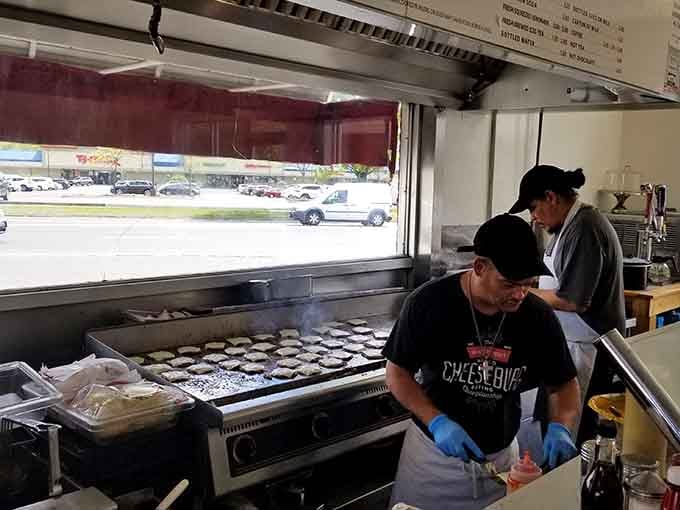 The flat-top grill works overtime, turning out perfectly crispy burgers with the efficiency of a Swiss watch.