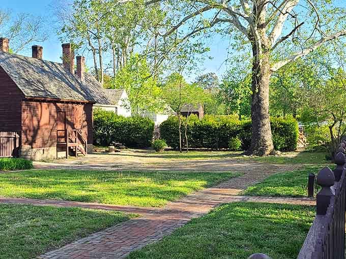 Golden hour sunlight filtering through trees onto brick paths, where every corner looks like a Thomas Kinkade painting came alive.