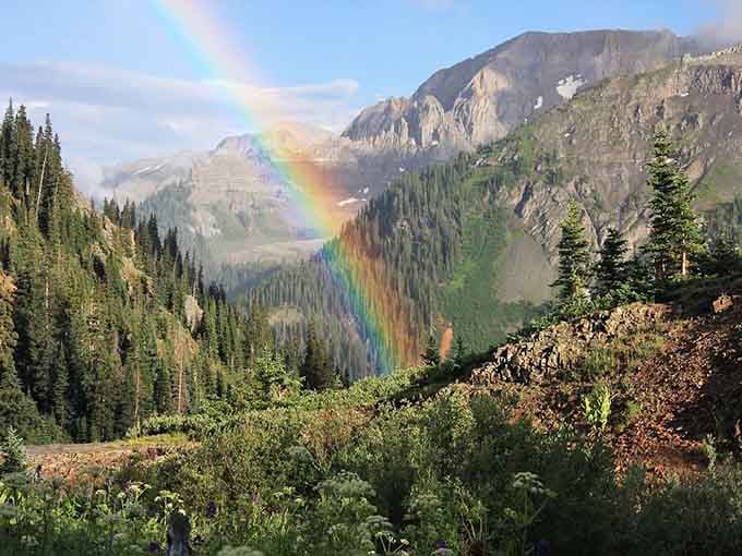 Rainbows appear after afternoon storms, adding magical finishing touches to already spectacular mountain scenery.
