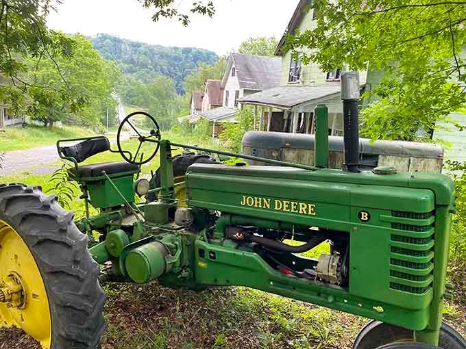 Even this old John Deere tractor couldn't escape the village's fate, now rusting peacefully among the abandoned homes.
