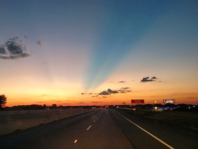 Sunset paints the highway in golden hues, turning an ordinary commute into something almost magical and memorable.
