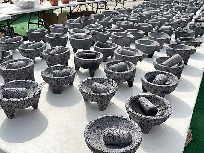 Stone mortars and pestles gather like an ancient cooking convention, ready to grind spices the old-fashioned way.