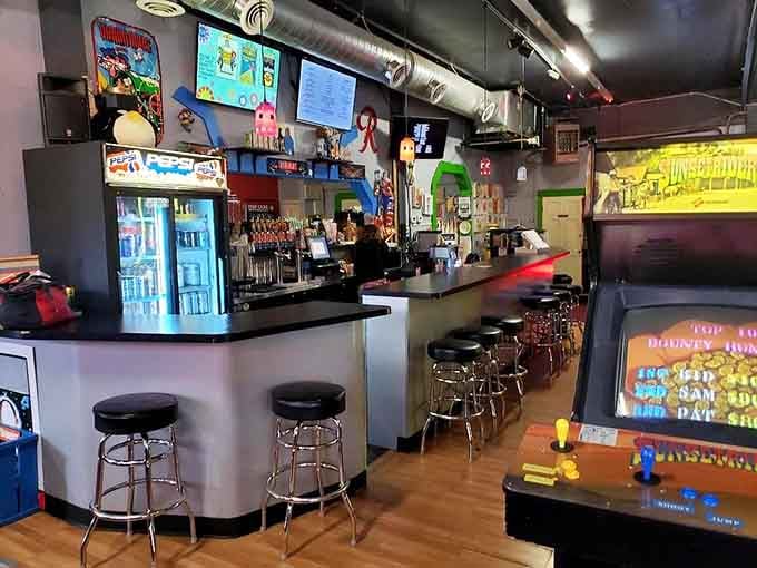 The bar area seamlessly blends craft beverages with classic gaming, because adulting should come with some serious perks and cold beer.
