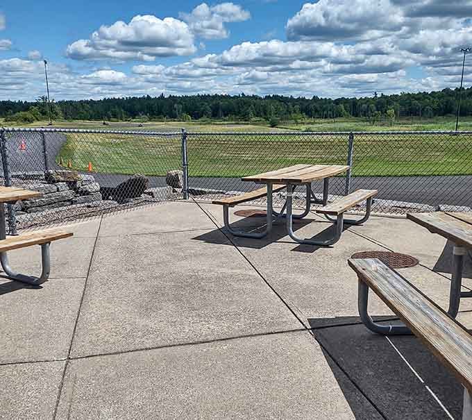 Picnic tables offering prime real estate for post-race trash talk and pre-mini golf strategy sessions with your crew.
