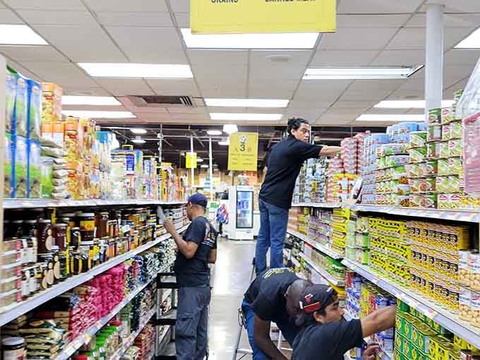 Staff restocking shelves with the kind of efficiency that keeps this global marketplace running smoothly every single day.