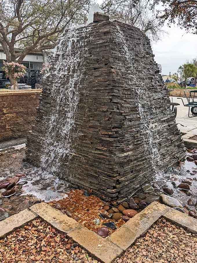 This fountain's gentle cascade is the soundtrack to your lunch, drowning out the world's chaos one splash at a time.