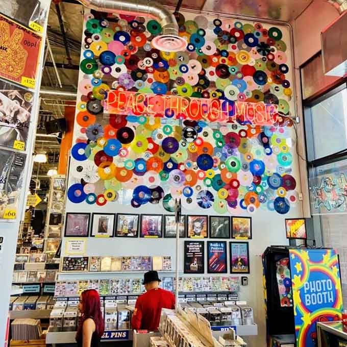 That colorful vinyl art installation celebrates the store's mission: spreading peace, one record at a time, beautifully displayed.