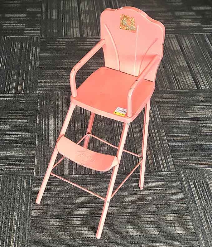 A pink vintage high chair that's equal parts nostalgia and practicality, minus the lead paint concerns.