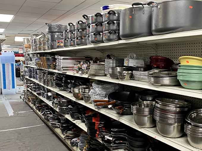 Cookware stacked like a metallic mountain range, ready to transform you into the chef you pretend to be.
