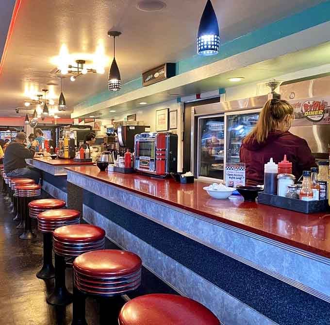 Those chrome stools at the counter offer front-row seats to the diner magic happening behind the scenes.
