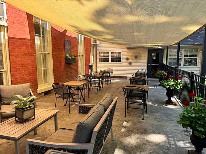 An outdoor patio where you can enjoy Kentucky weather alongside your meal, complete with comfortable seating and flowering plants.