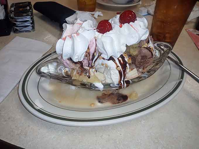 Banana split that's basically three desserts pretending to be one, topped with cherries and zero shame whatsoever here.