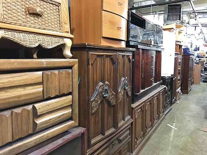 Furniture displays showcasing everything from rustic charm to ornate elegance, all under one warehouse roof.