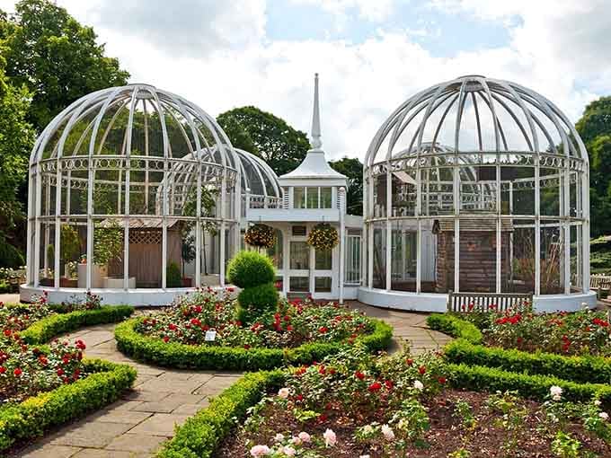Victorian-style glasshouses stand like elegant sentinels, protecting tender plants from Alabama's occasionally dramatic weather mood swings.